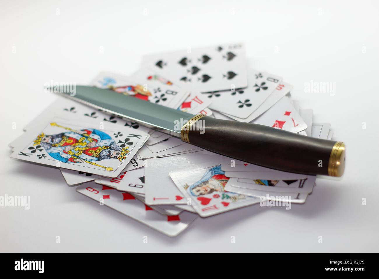 Knife lying on a deck of cards Stock Photo - Alamy