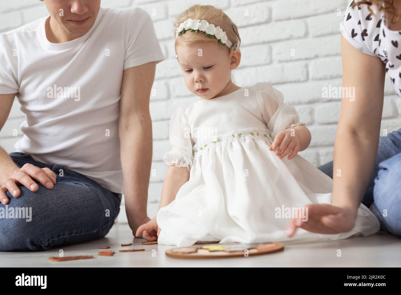 Baby child with hearing aids and cochlear implants plays with parents ...