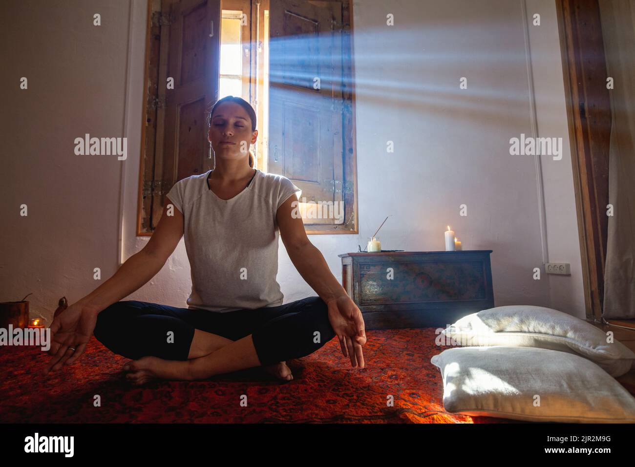 Young women practicing lotus position at home Stock Photo - Alamy