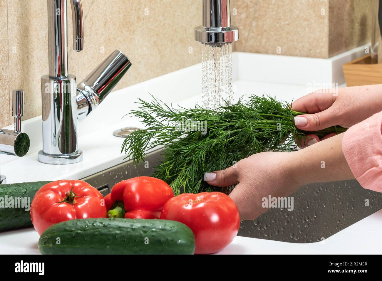 Women's hands wash vegetables in the kitchen in the sink Stock Photo ...