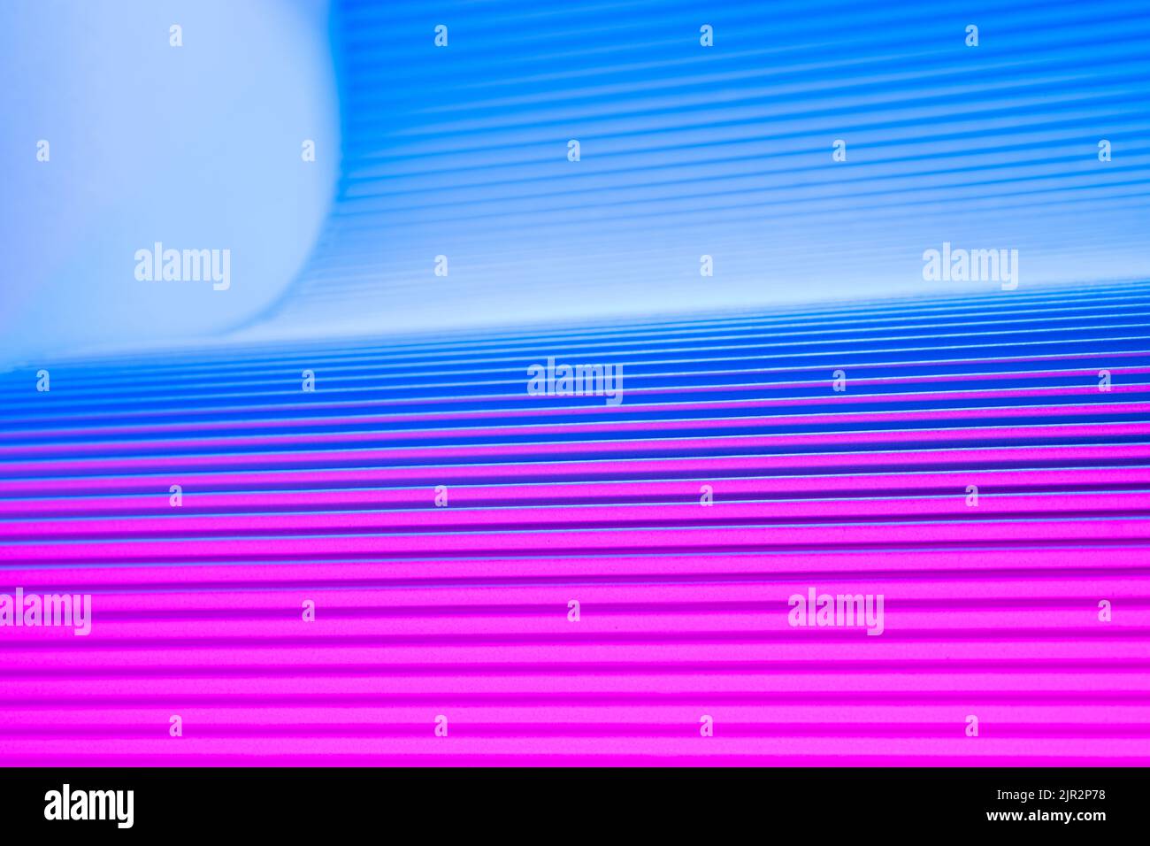 Neon hues over corrugated magenta and blue background. Futuristic ...
