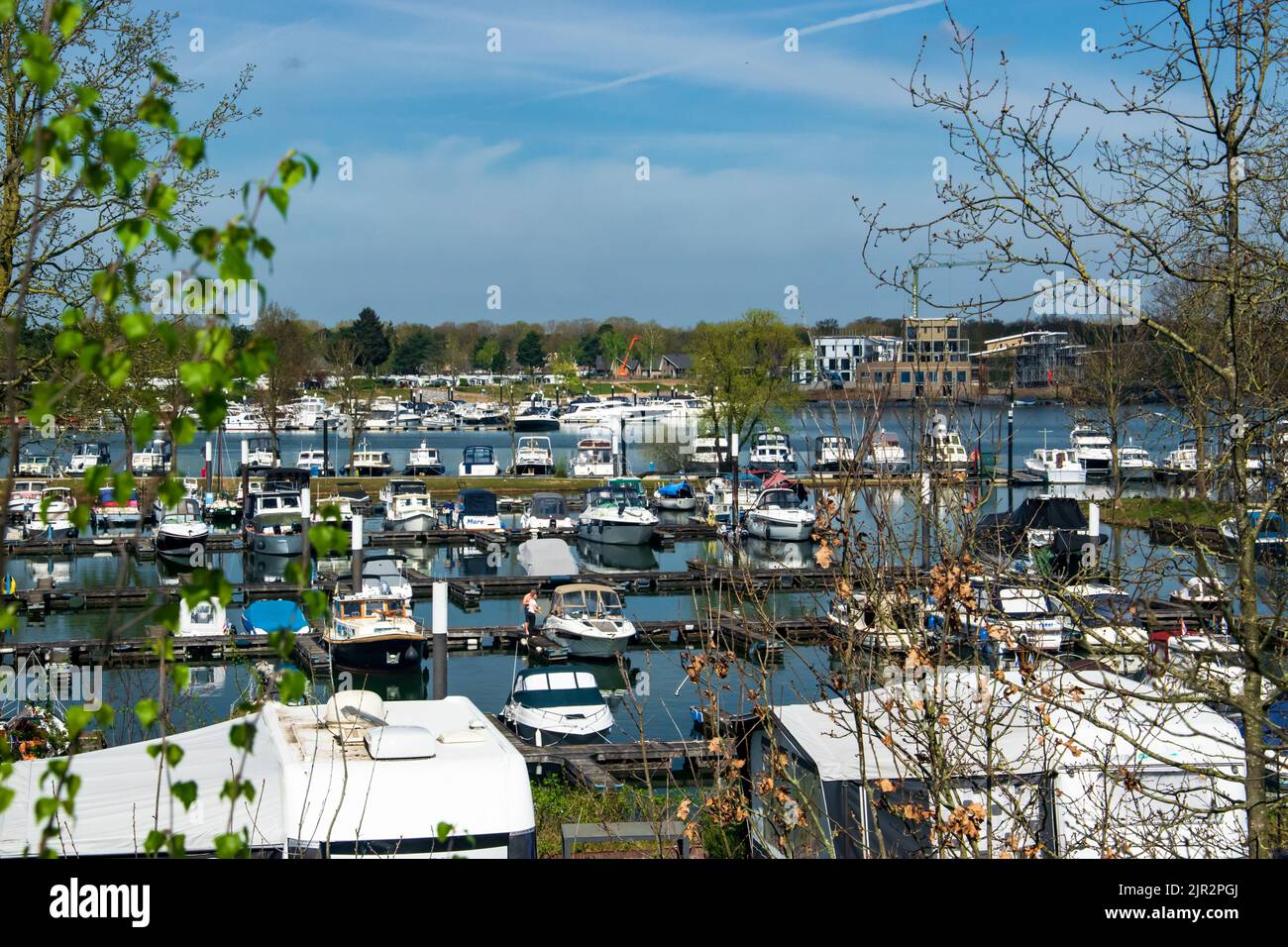A small harbor with white boats in a rural area in Limburg, the ...
