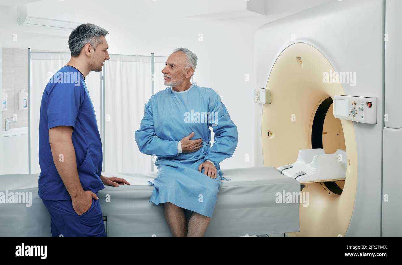 Radiologic technologist listening to senior patient's complaints ...