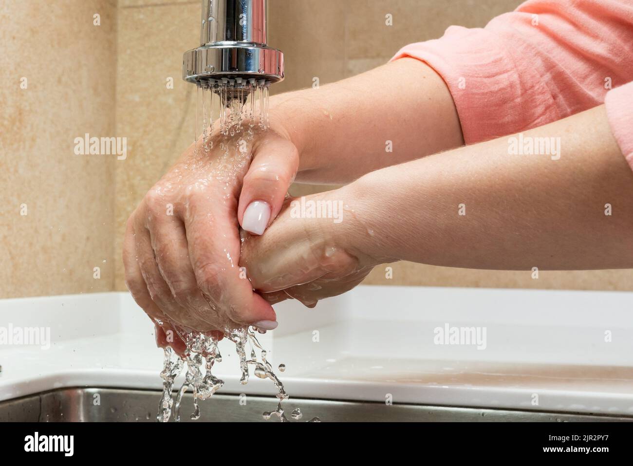 Washing female well-groomed hands in the kitchen close-up Stock Photo ...