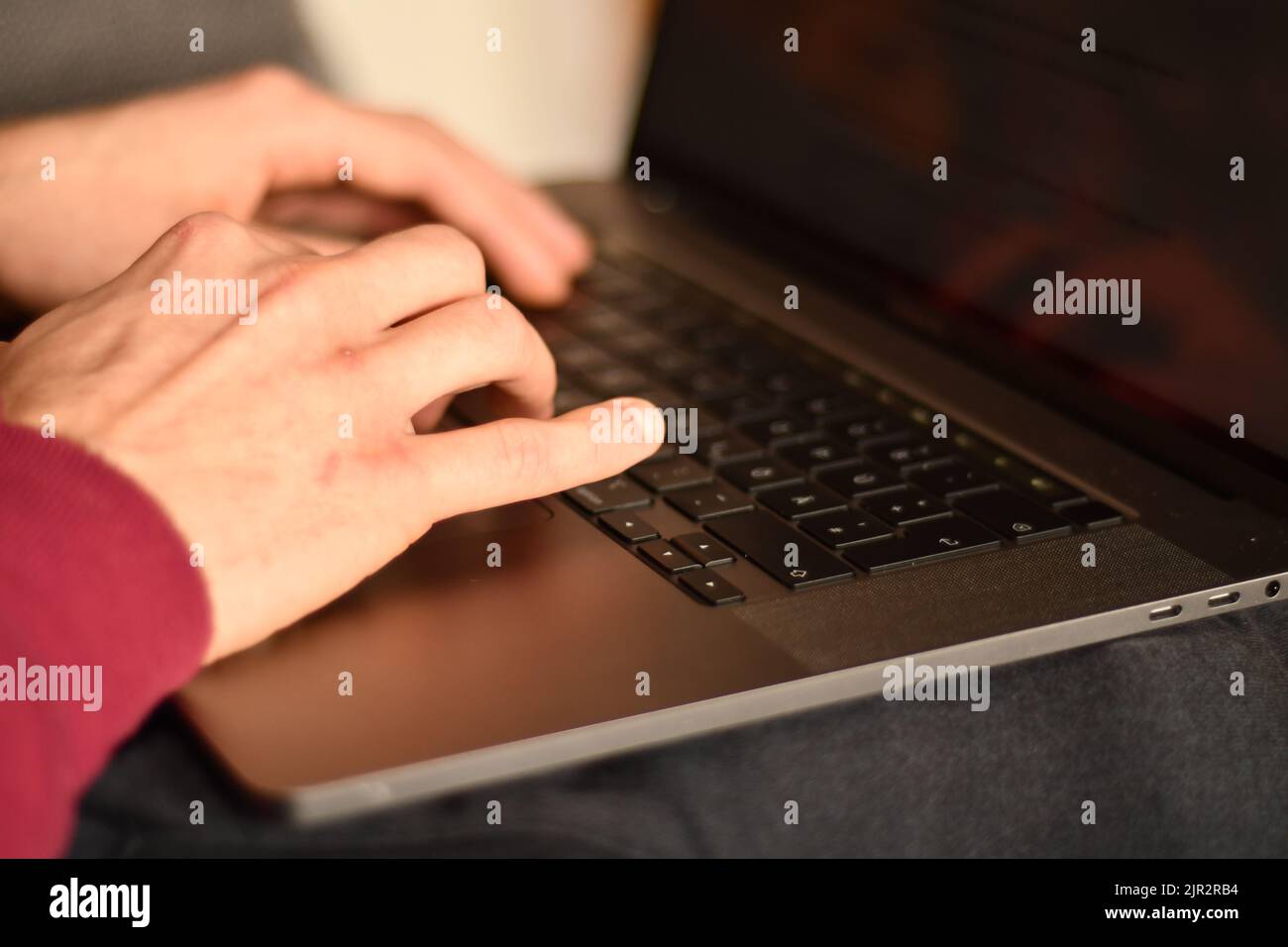 The hands typing on the keyboard of a notebook Stock Photo - Alamy