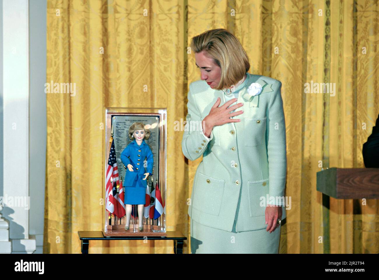 U.S First Lady Hillary Clinton reacts after being presented with a doll ...