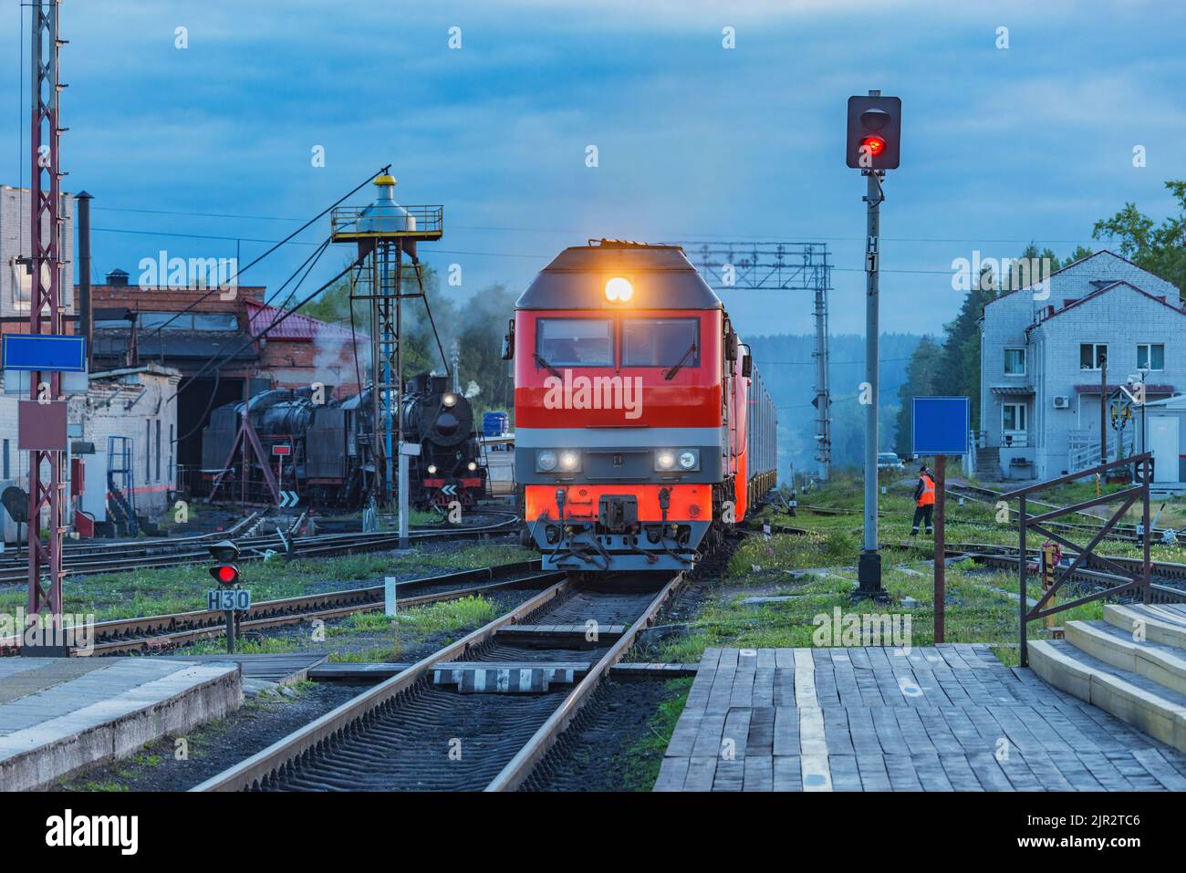 Passenger train approaches to the wooden platform Stock Photo - Alamy