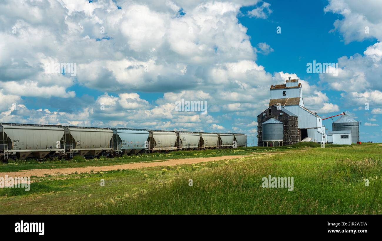 The grain storage elevator and train cars at Bromhead, Saskatchewan ...