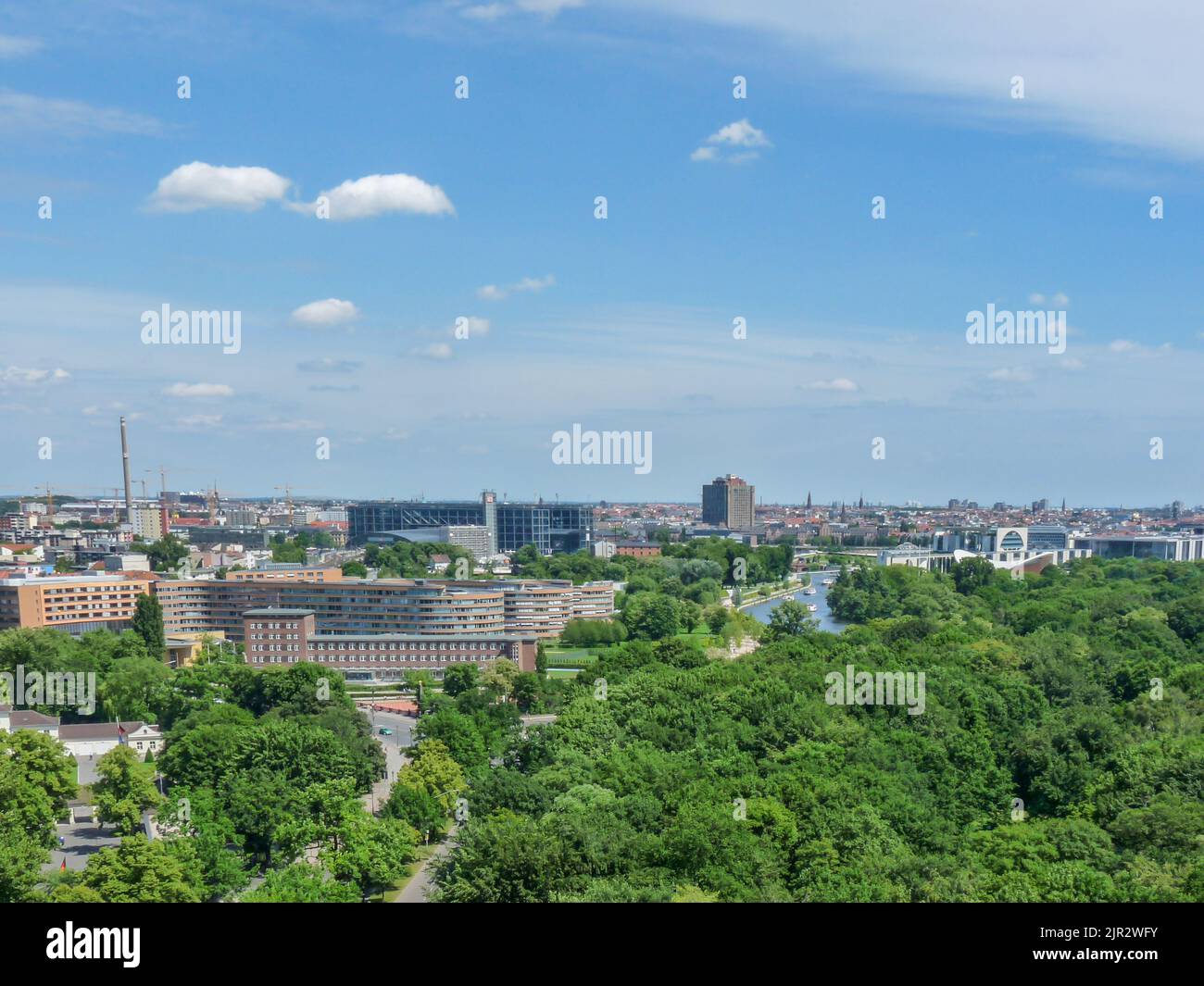 An aerial view of lush green forests and Berlin cityscape in Germany ...
