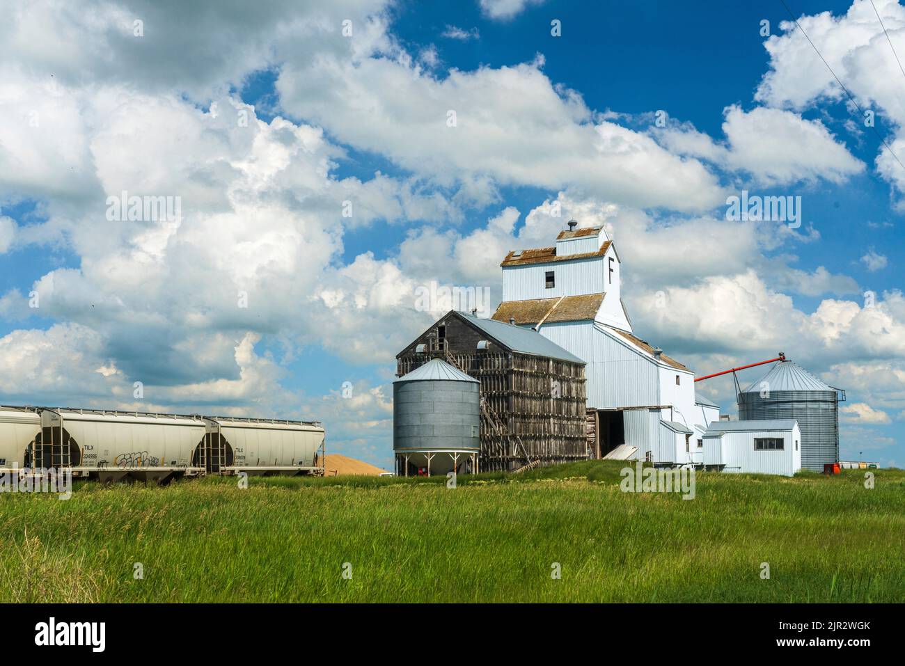The grain storage elevator and train cars at Bromhead, Saskatchewan ...