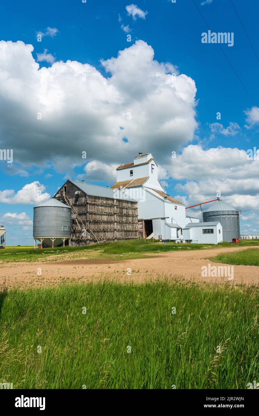 The grain storage elevator and train cars at Bromhead, Saskatchewan ...
