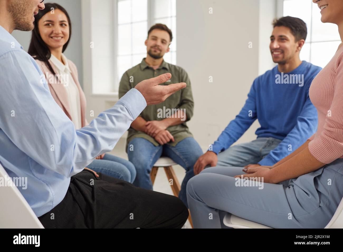 Group of happy young people having a discussion during a business ...