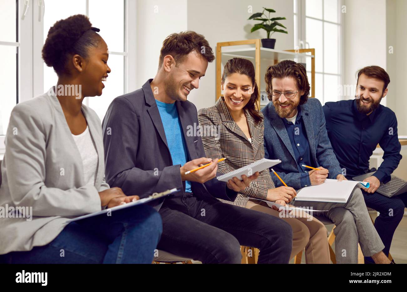 Young happy multiracial people men and woman working in modern company ...