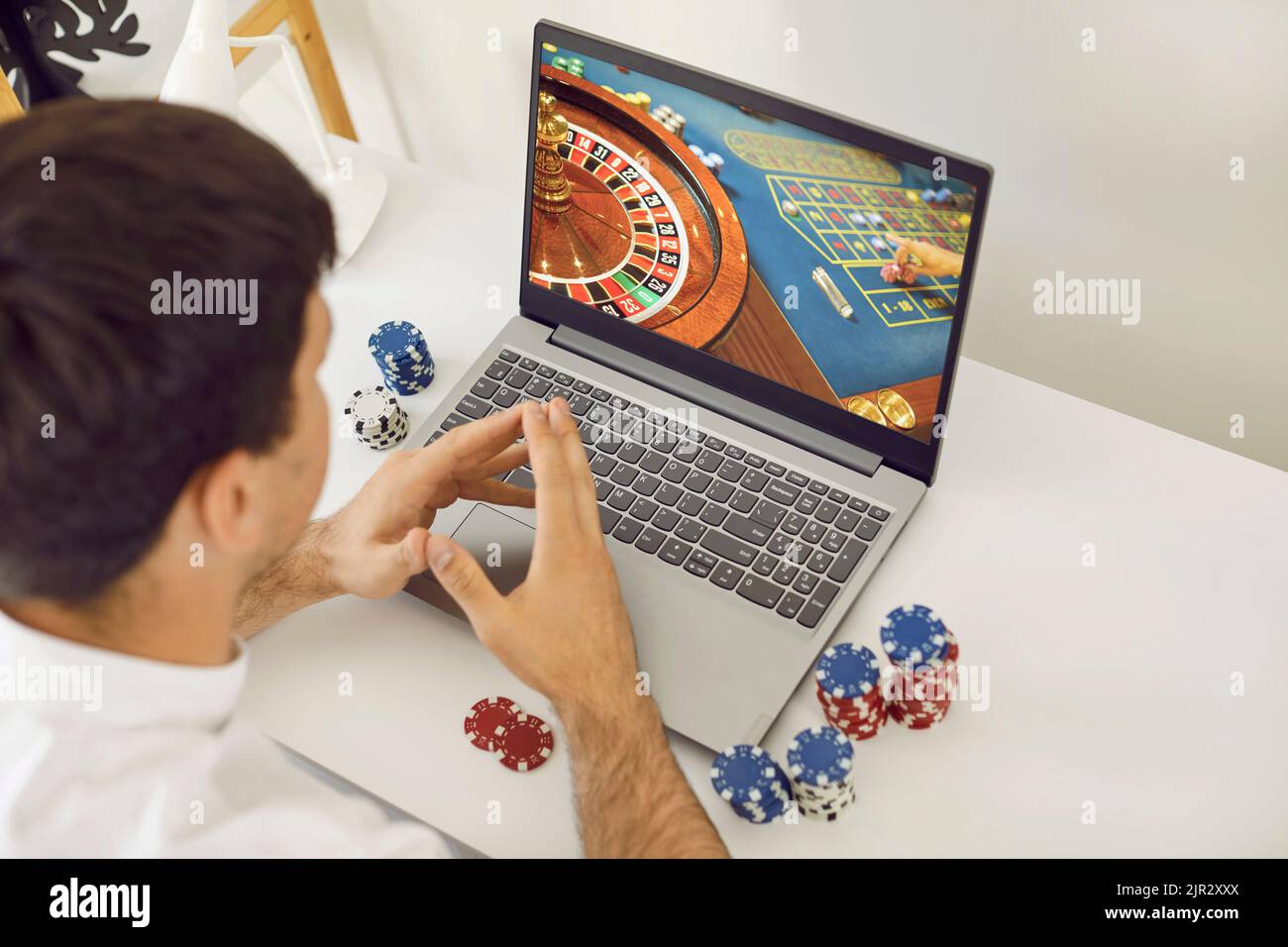 Playing poker on his laptop hi-res stock photography and images - Alamy