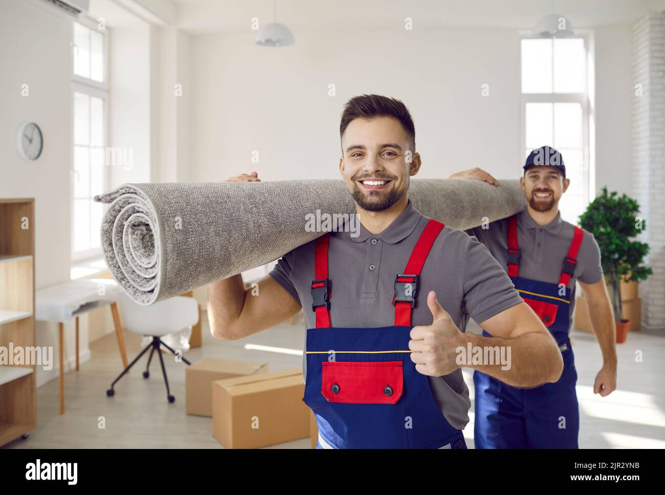 Male carriers recommend good quality delivery service Stock Photo - Alamy