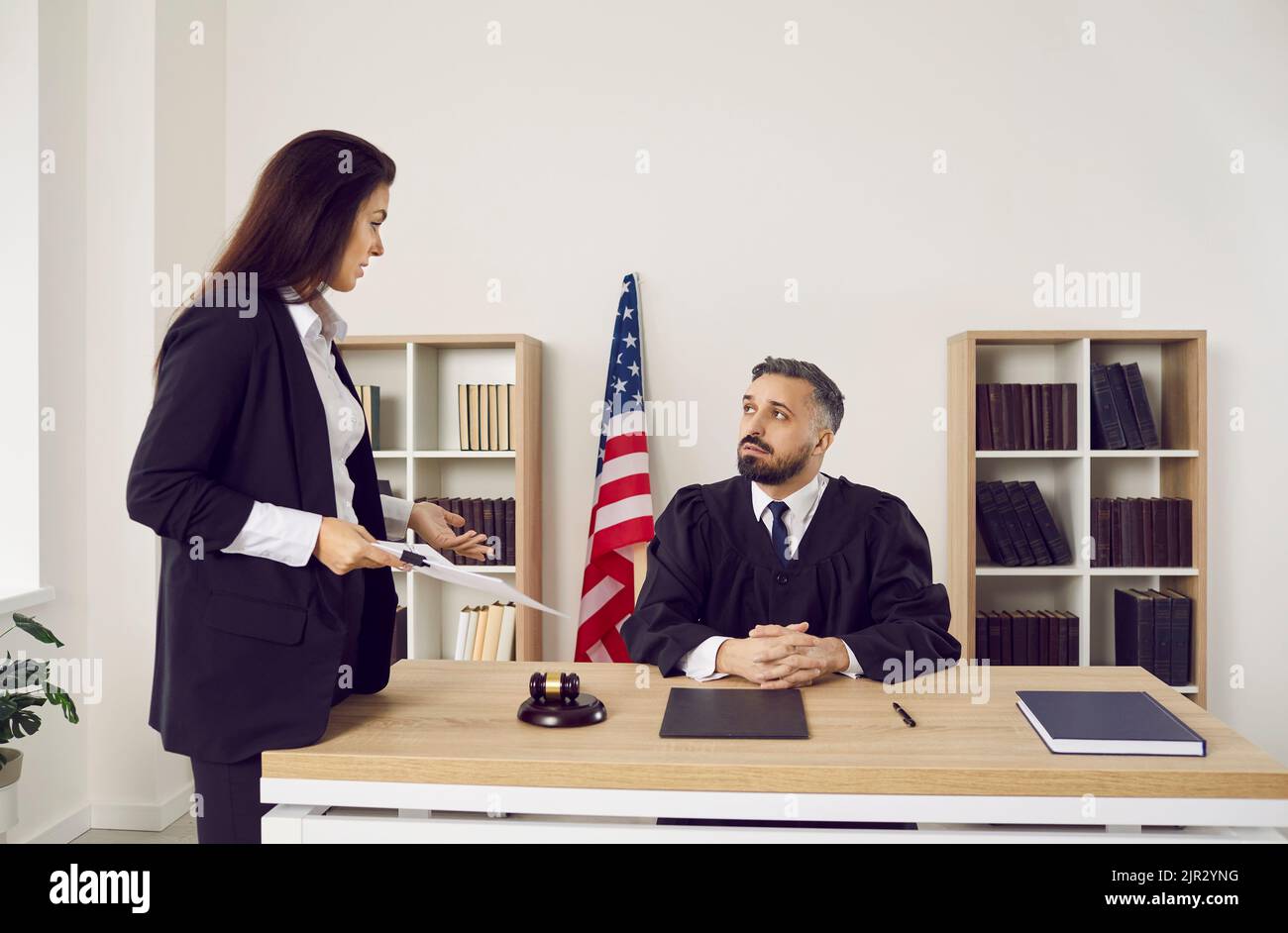 American attorney and judge talking about something during a court ...