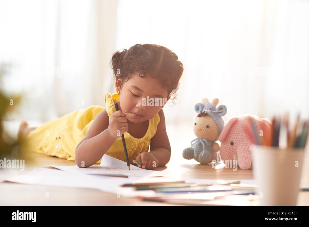 Cute baby girl enjoying drawing pictures in her room Stock Photo - Alamy
