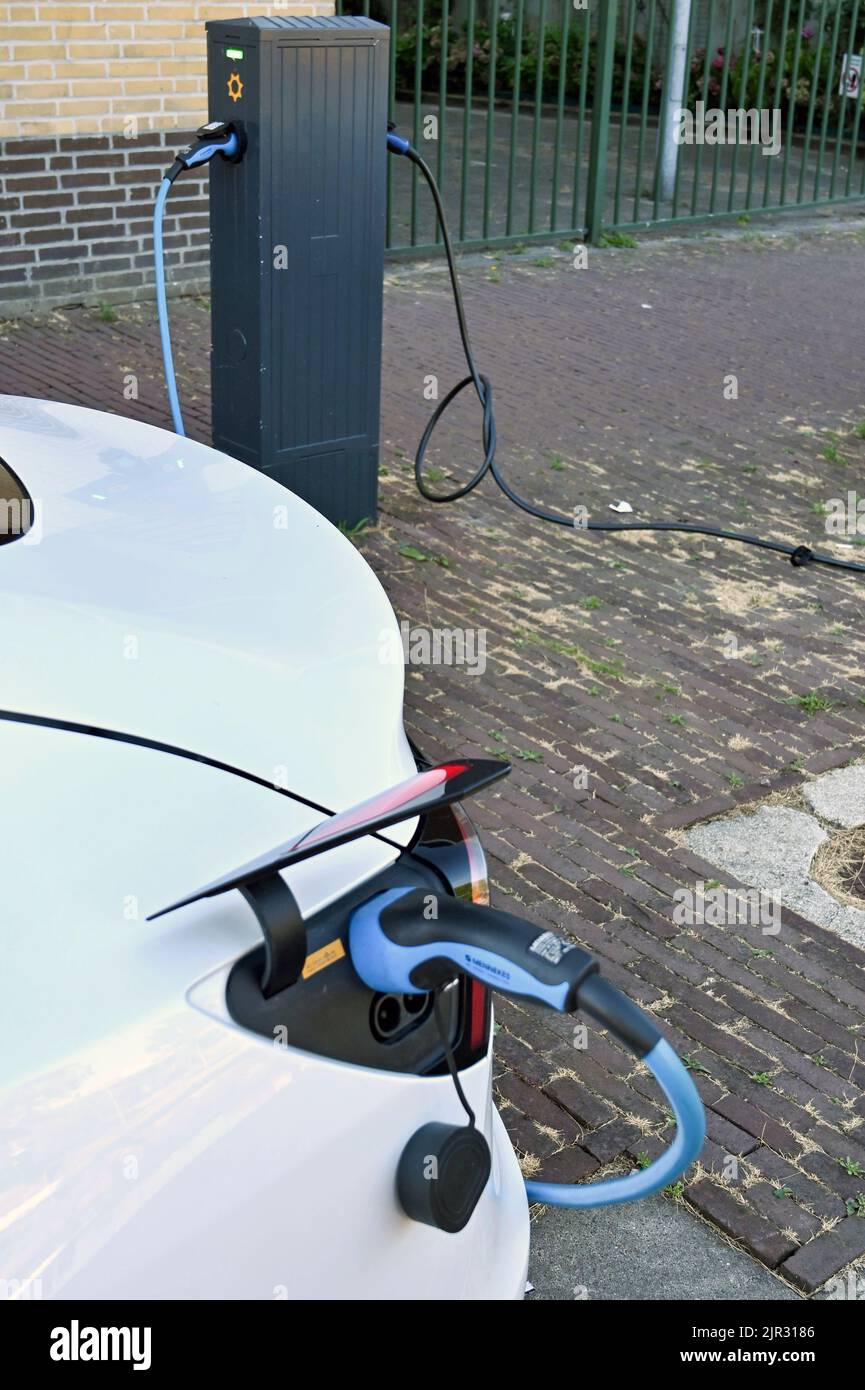 Utrecht, Netherlands - August 2022: Cable plugged in to recharge a ...