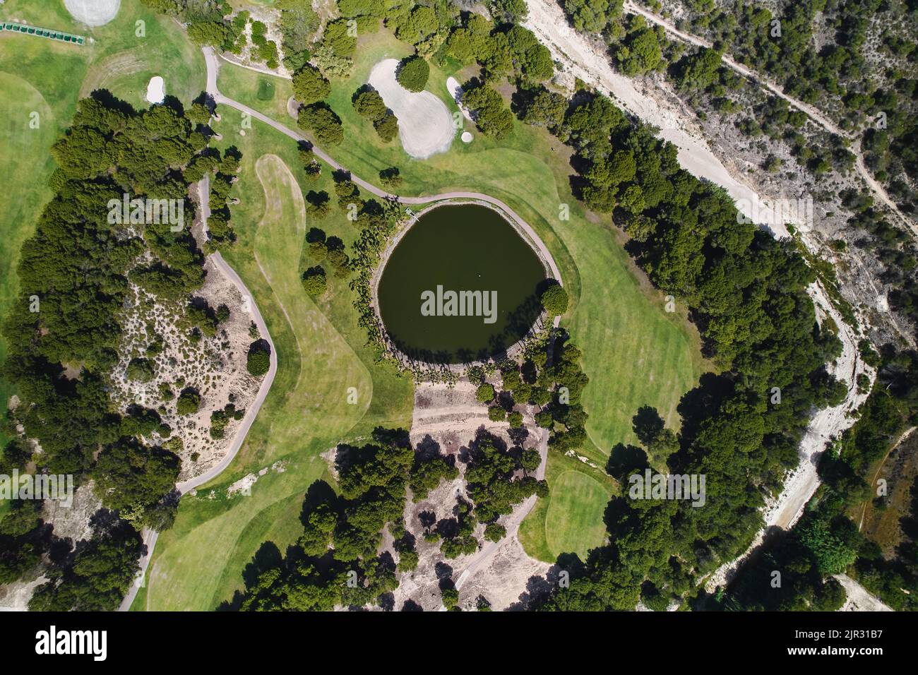 Aerial view from above golf course with lush green fields and lake ...