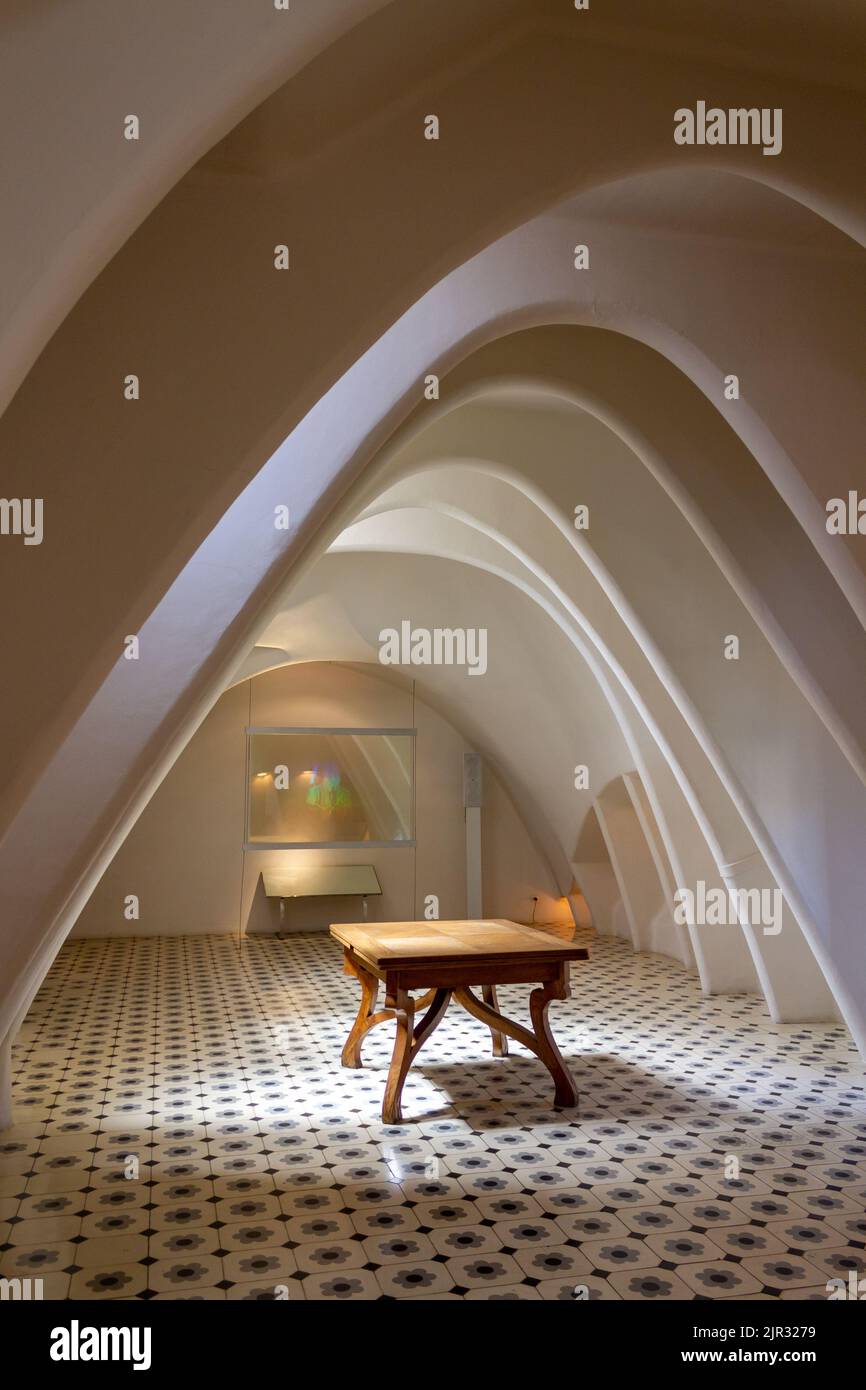 A vertical shot of the interesting interior of Casa Mila with arched ...