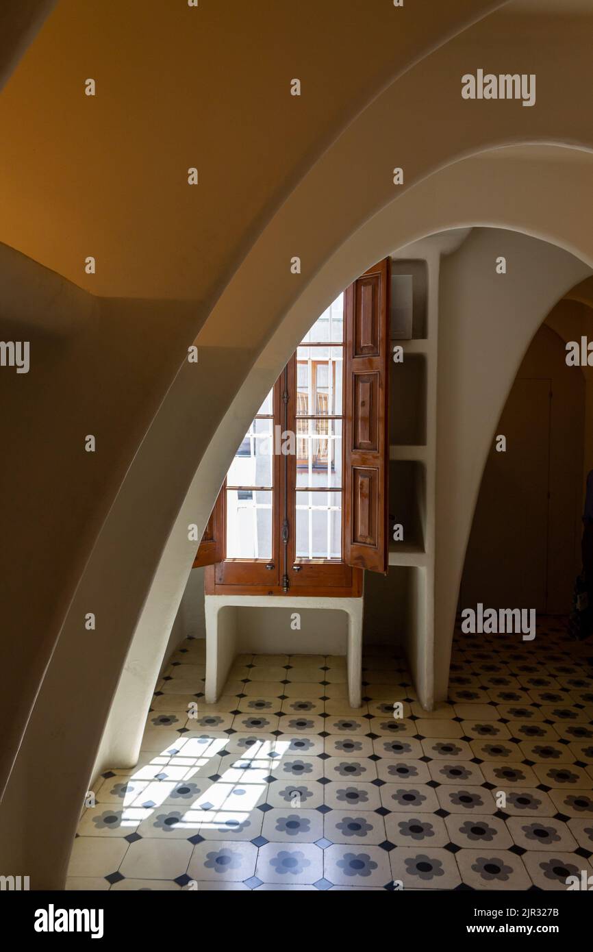 A vertical shot of the interesting interior of Casa Mila with arched ...