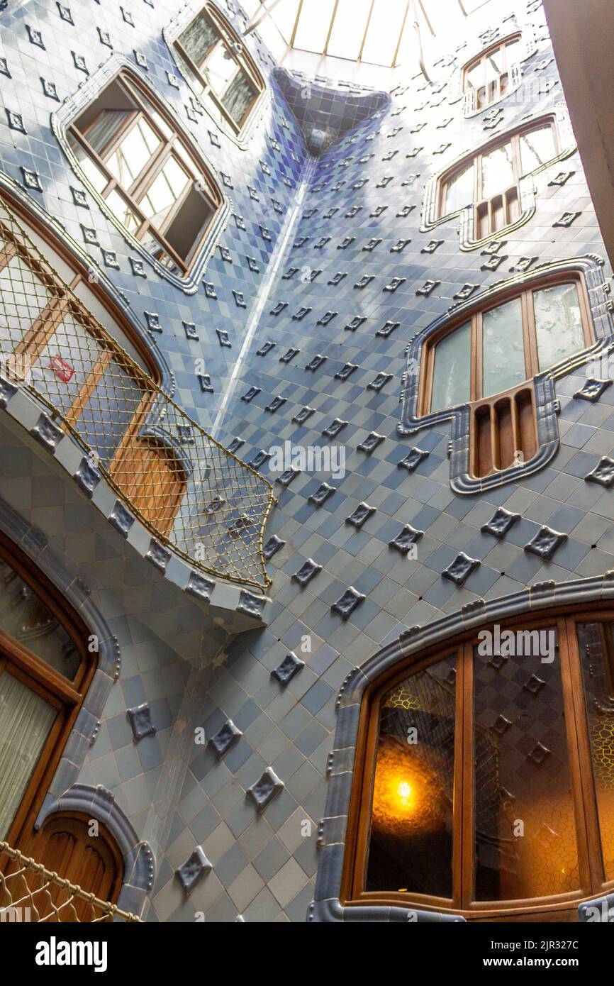 A low angle shot of the blue tiled walls with windows in Casa Mila in ...