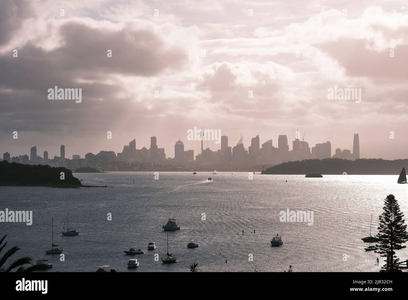 The beautiful scenery of calm sea with boats and silhouette of a modern ...