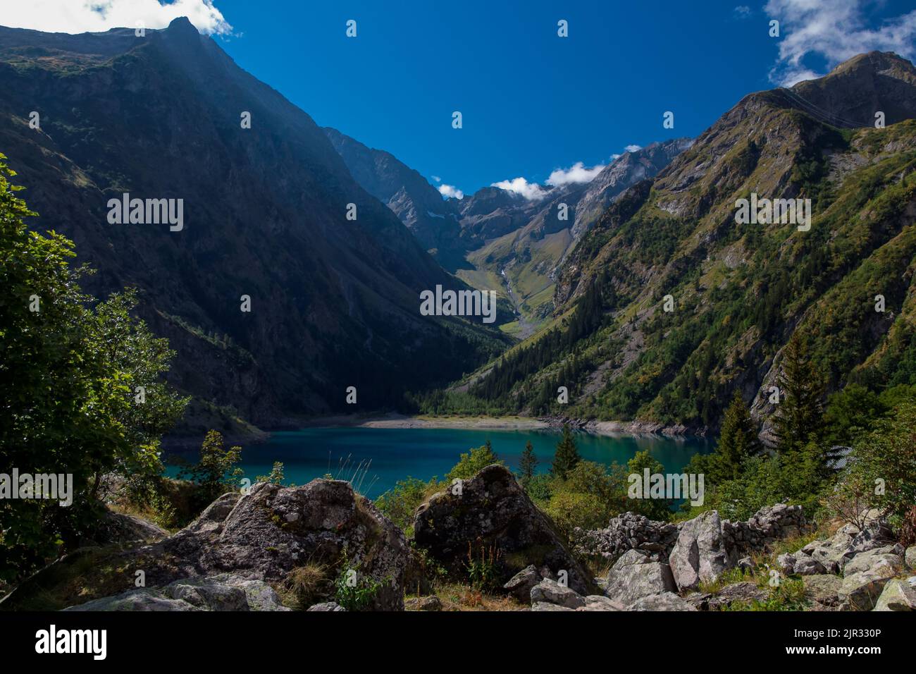 A landscape view of the beautiful Lac du Lauvitel lake surrounded with ...