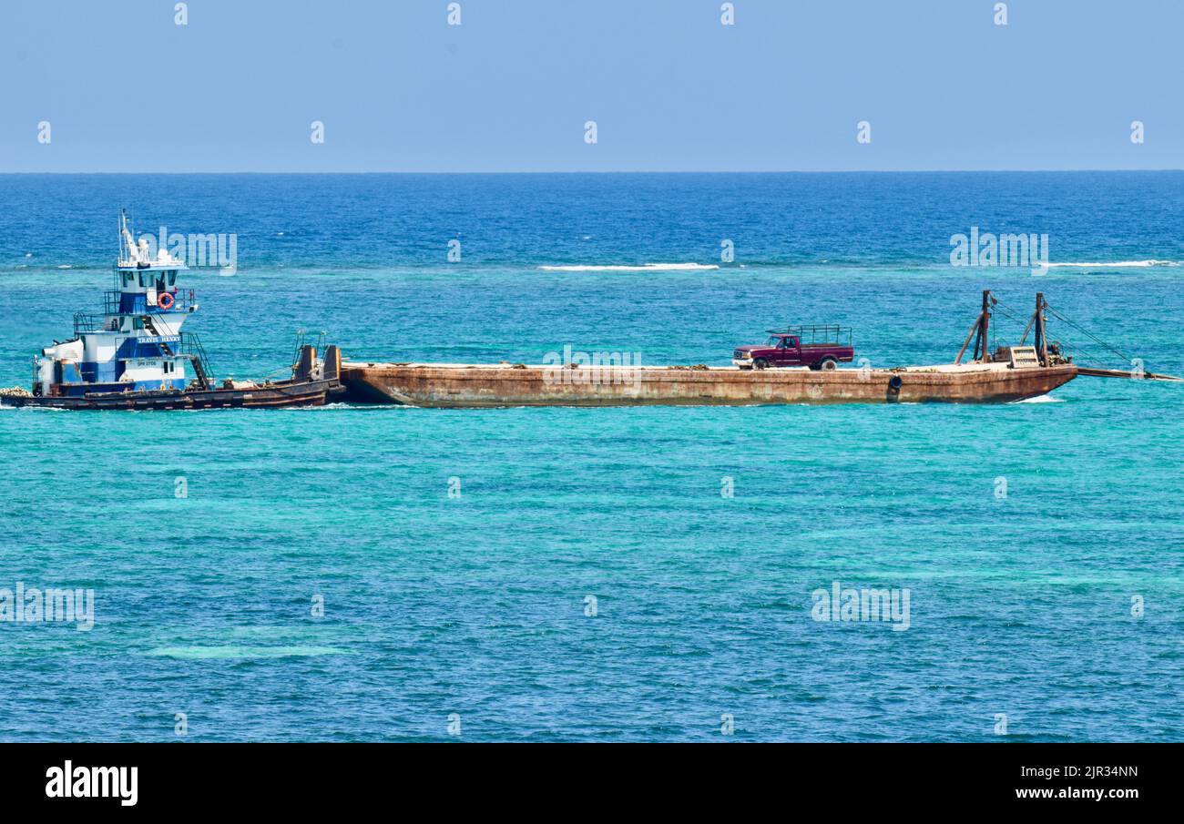 A barge transporting a red pick-up truck from Ambergris Caye to the ...