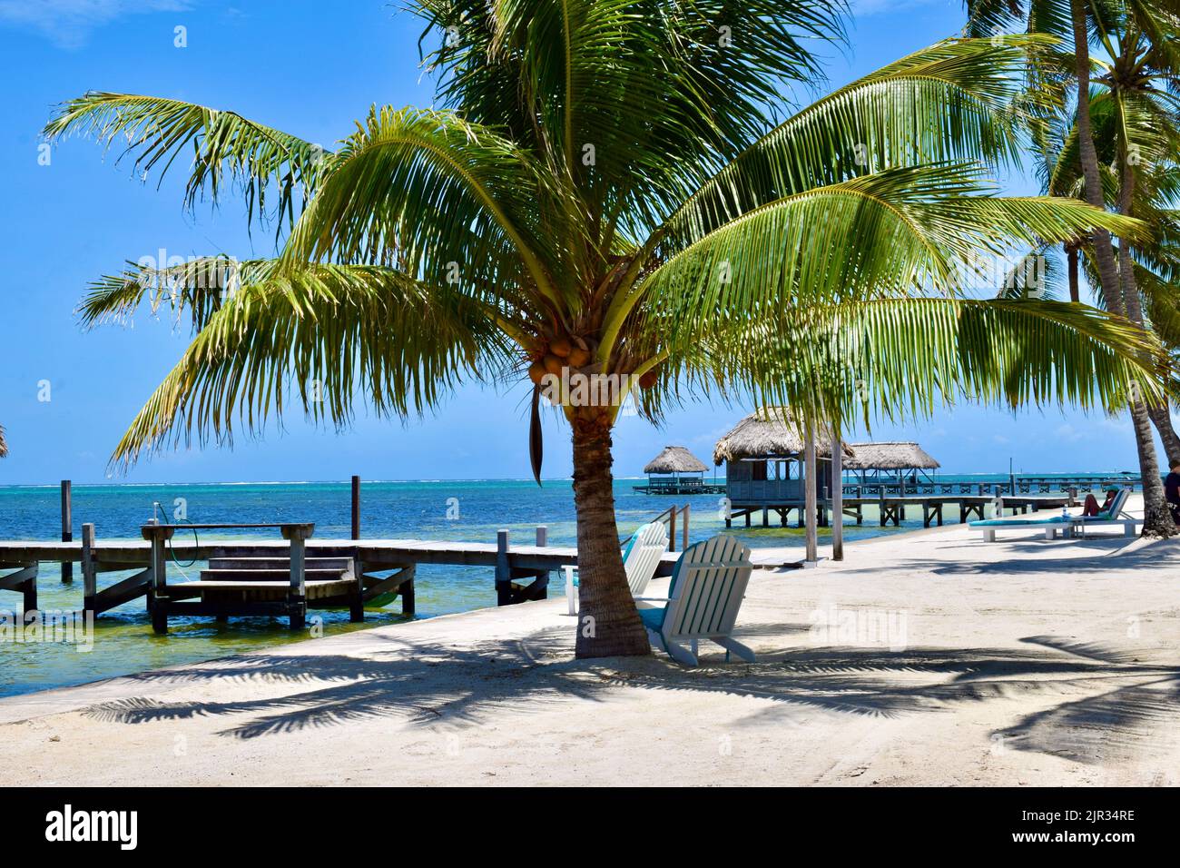 The white sand beach at a luxury beach resort on a sunny day, with ...