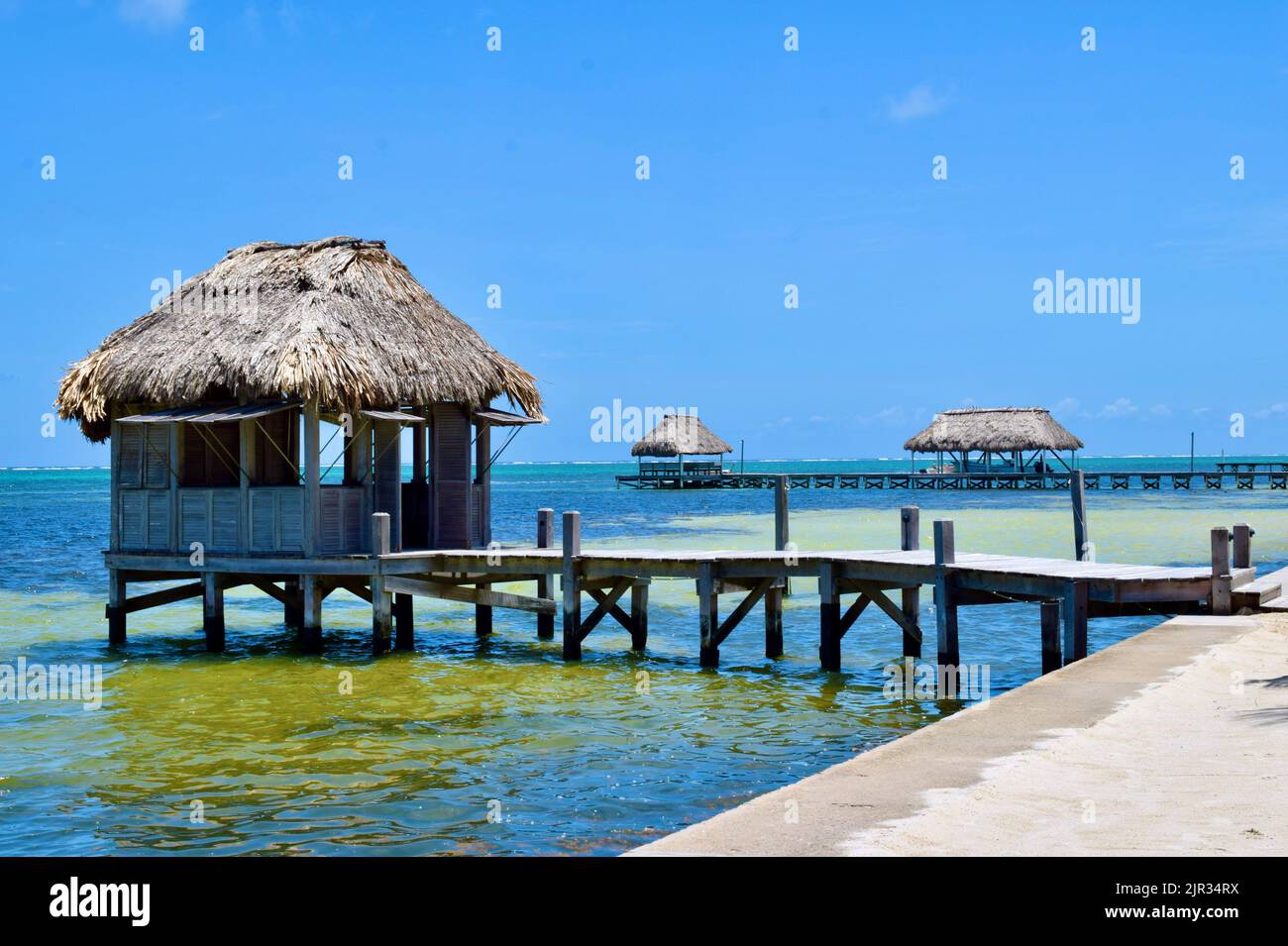 A palapa hut with a short pier at a beach resort on Ambergris Caye, San ...