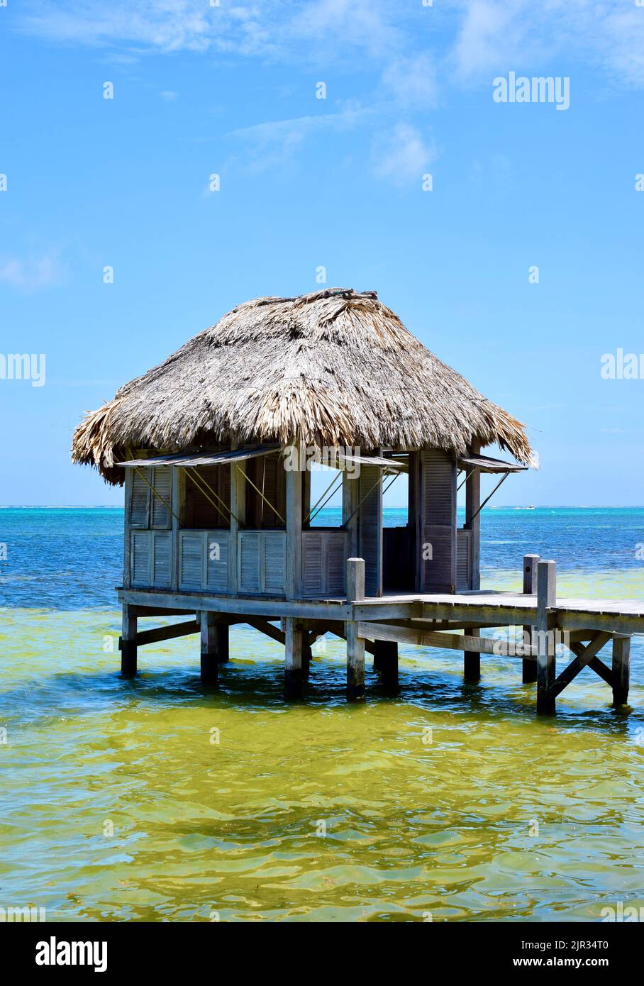 A palapa hut with a short pier at a beach resort on Ambergris Caye, San ...