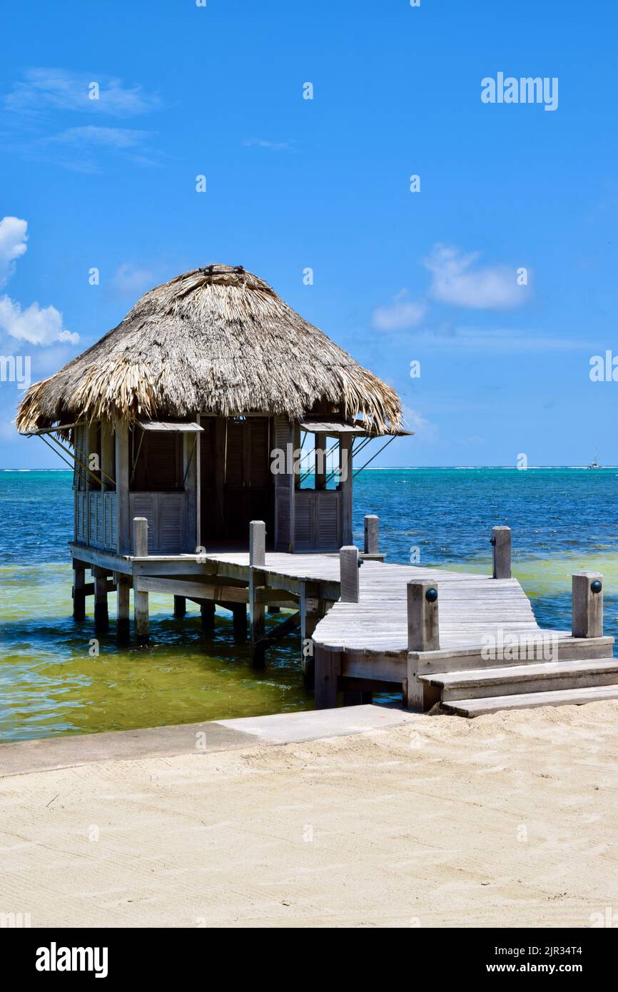 A palapa hut with a short pier at a beach resort on Ambergris Caye, San ...