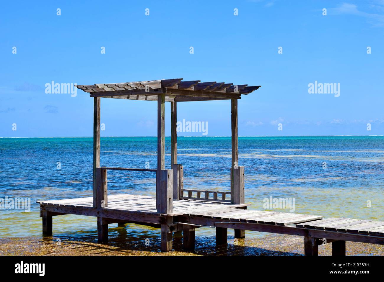 A peaceful scene of a gazebo, on a small pier over the water, on ...
