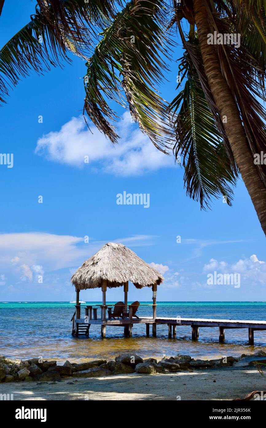 An idyllic spot on Ambergris Caye, San Pedro, Belize. Two chairs under ...