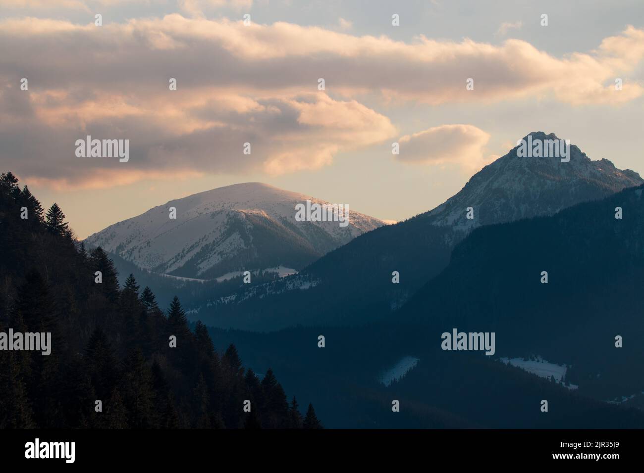 The snowcap mountains against cloudy sunset sky background Stock Photo ...