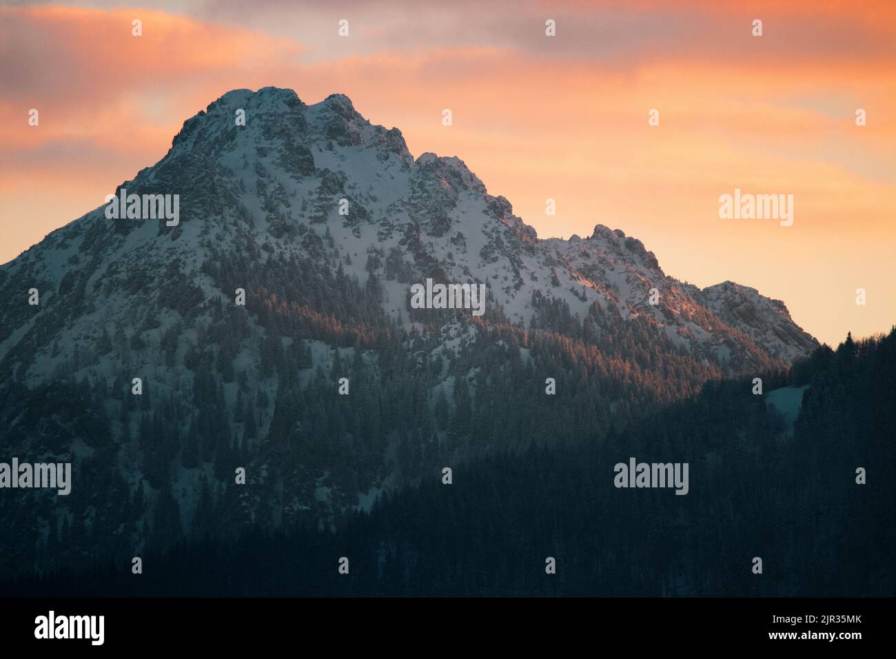 A snowcap mountain against colorful sunset sky background Stock Photo ...
