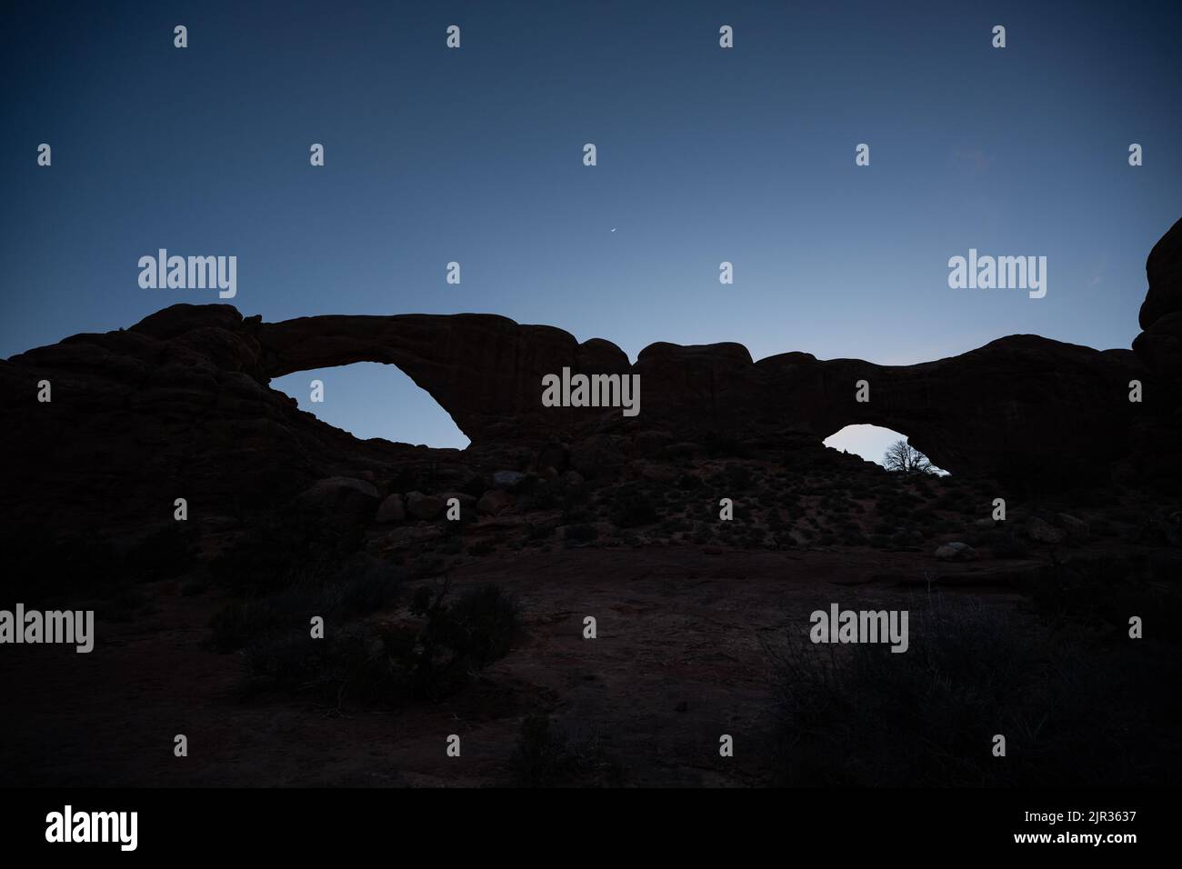 Tiny Sliver of The Moon Over The Spectacles in Arches National Park ...