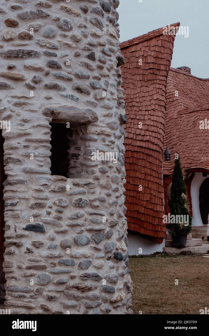 A stone tower and white funny fairytale-style castle in the park Stock ...