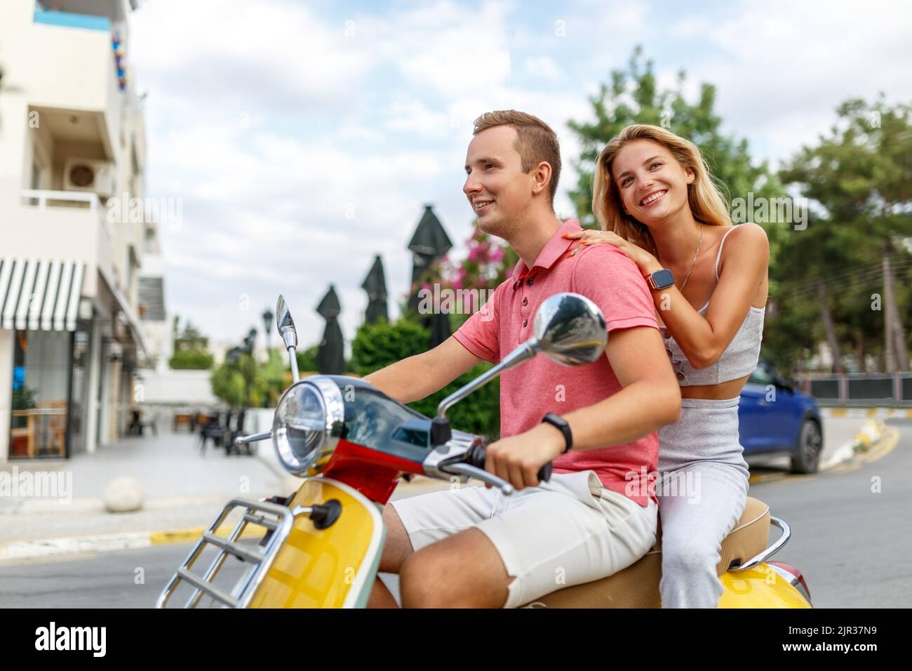 Happy couple in love riding a motorbike on summer city streets ,man and ...