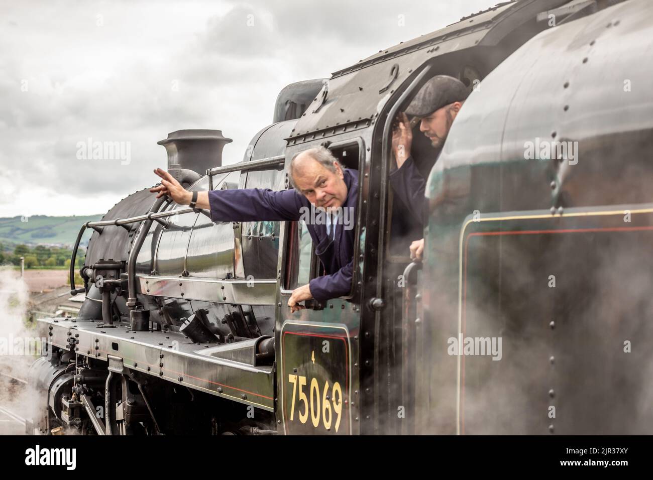 The driver of BR 4MT 4-6-0 No. 75069 accepts the 'right-away' to depart ...