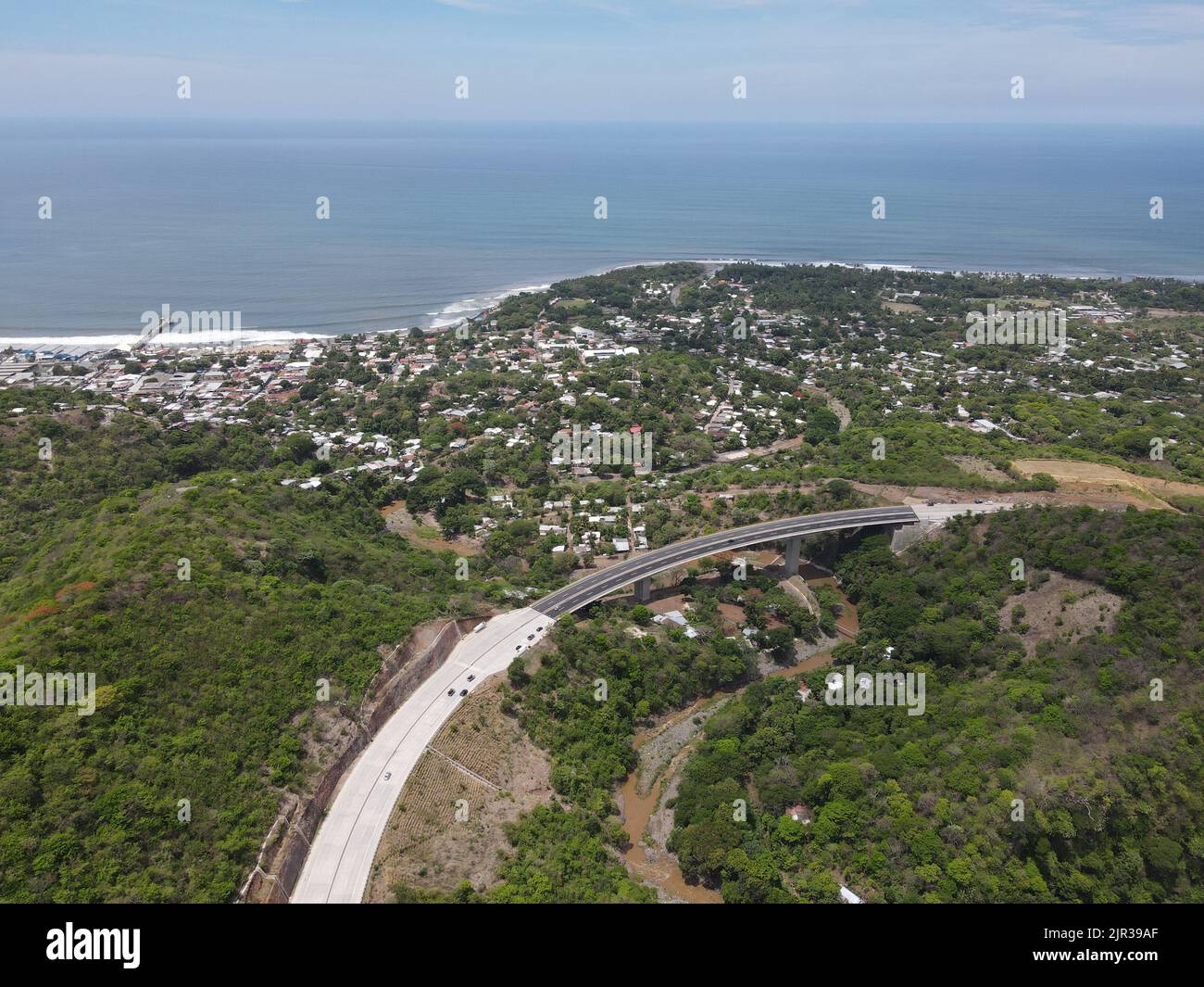 A drone view of a cityscape and a beach under blue sky Stock Photo - Alamy