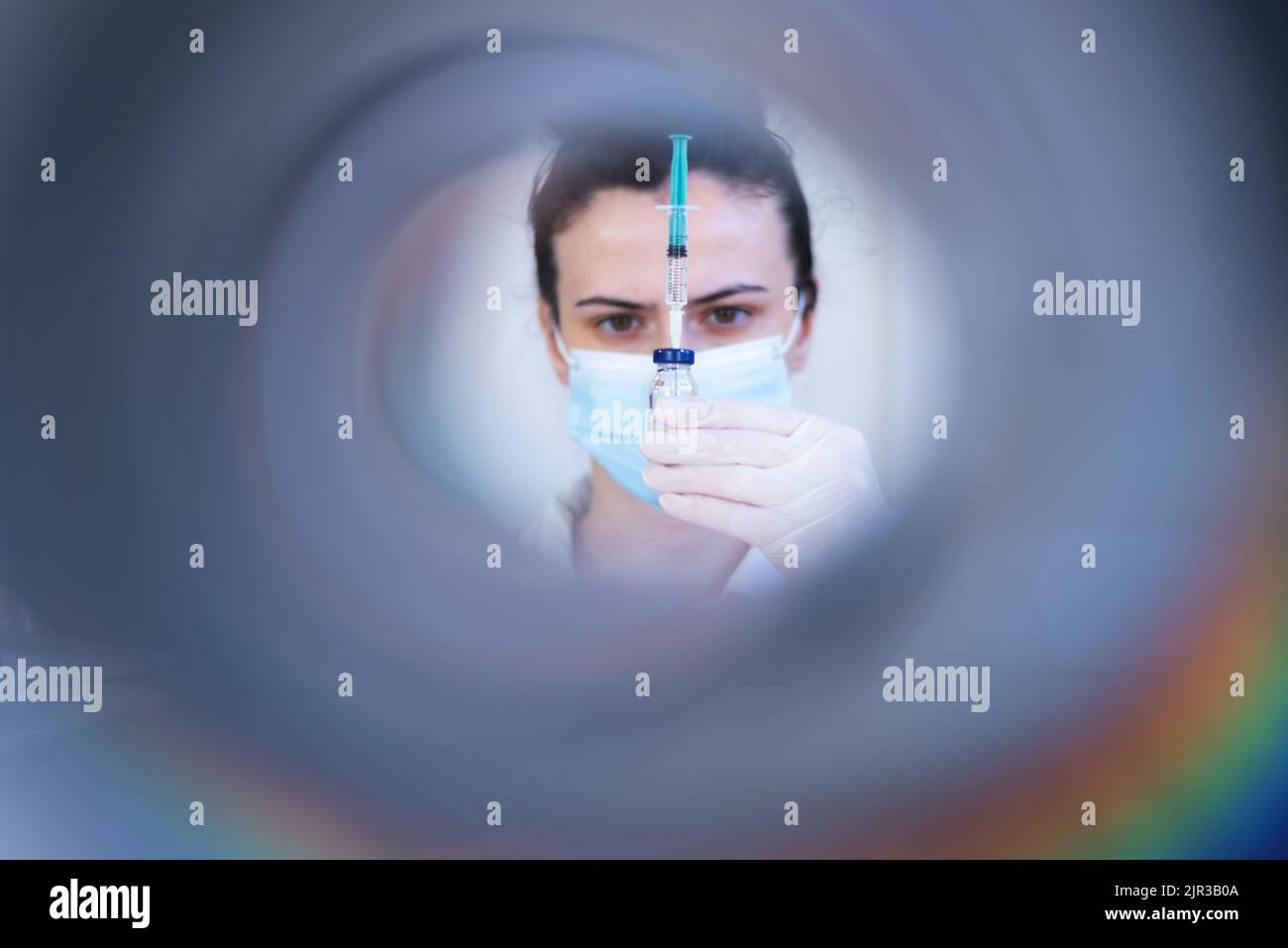 Female doctor preparing syringe. Beautiful nurse preparing a syringe ...