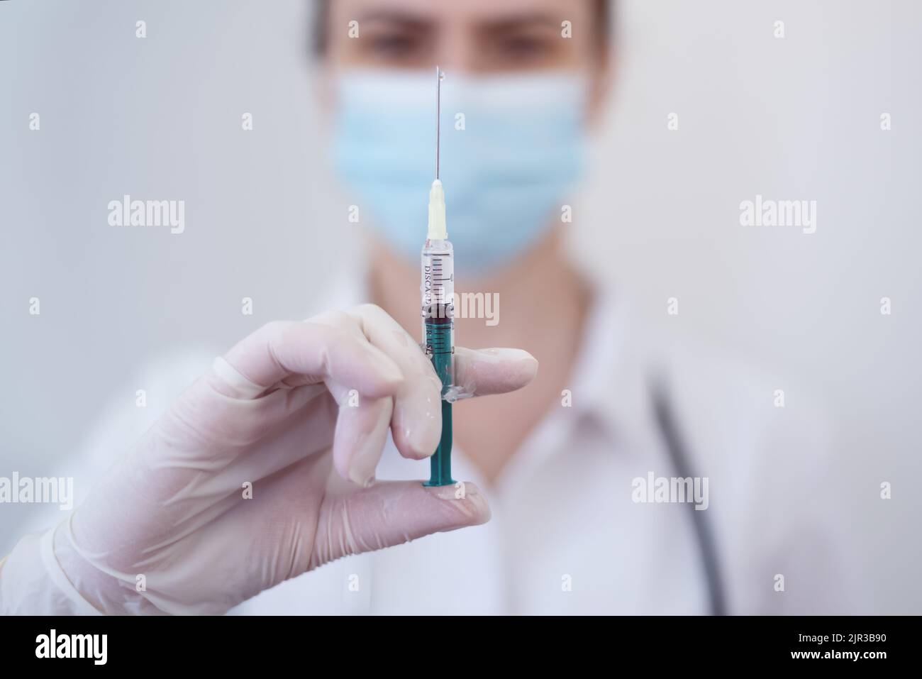 Female doctor preparing syringe. Beautiful nurse preparing a syringe ...
