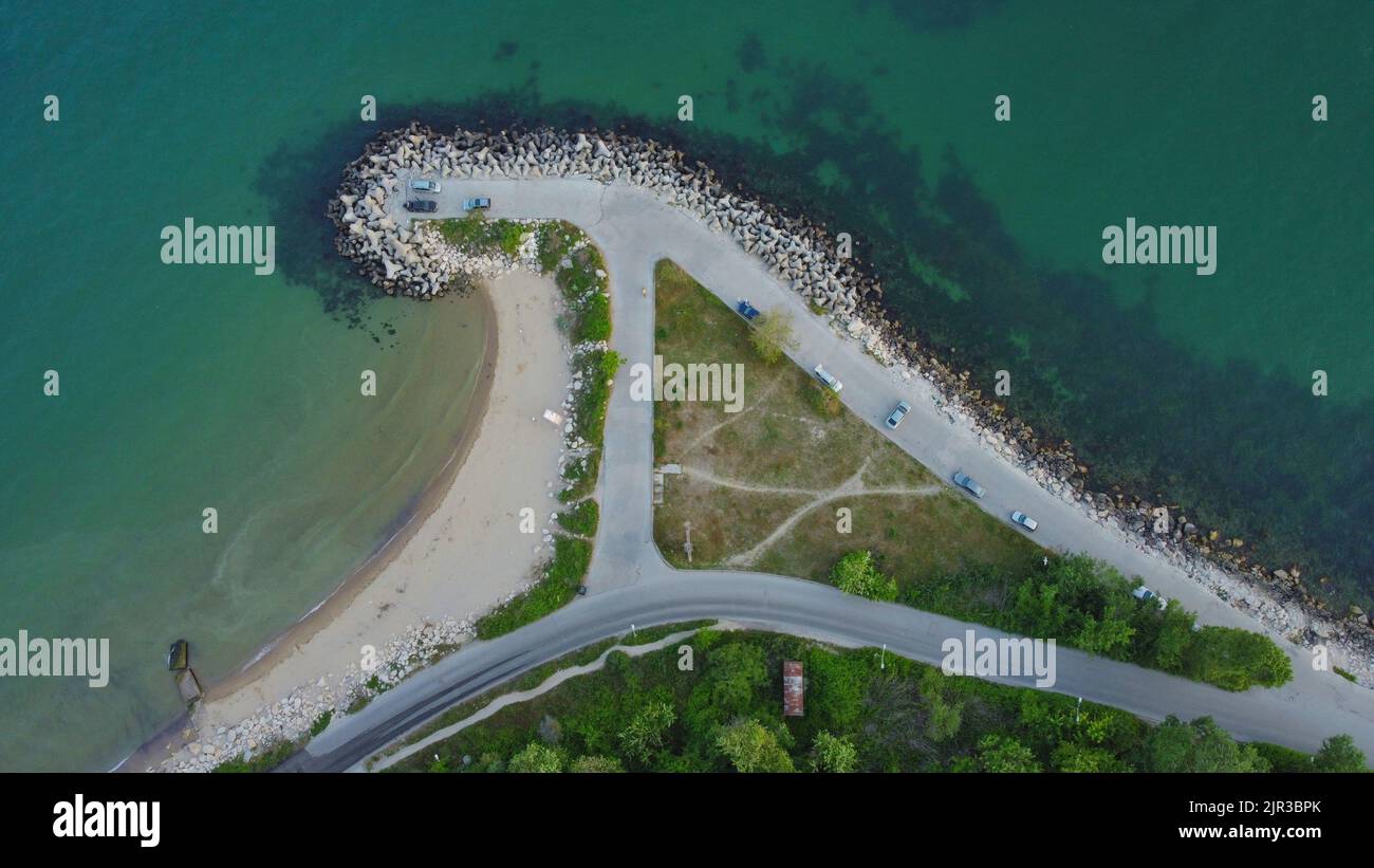 Aerial top view of the concrete wave breakers in a turquoise water and ...