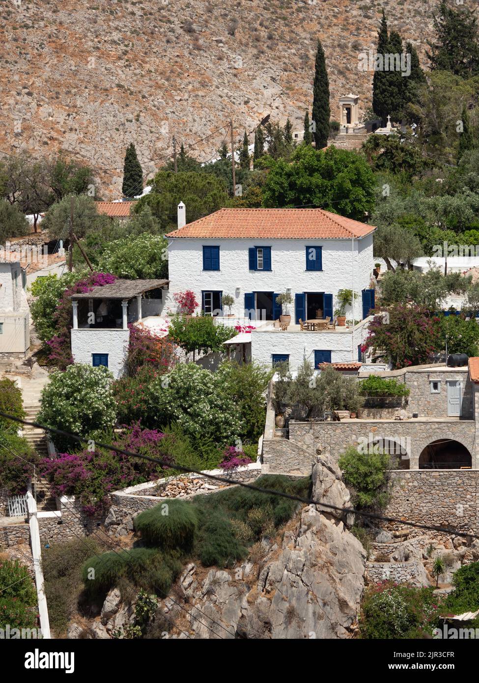 Greek villa with blue shutters and terracotta roof in Hydra, Greece ...