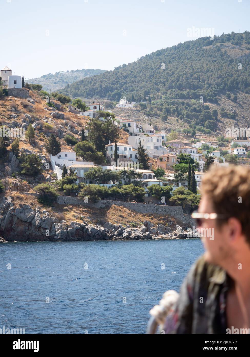 Boar trip, man in sunglasses looking at island from the boat, Hydra ...