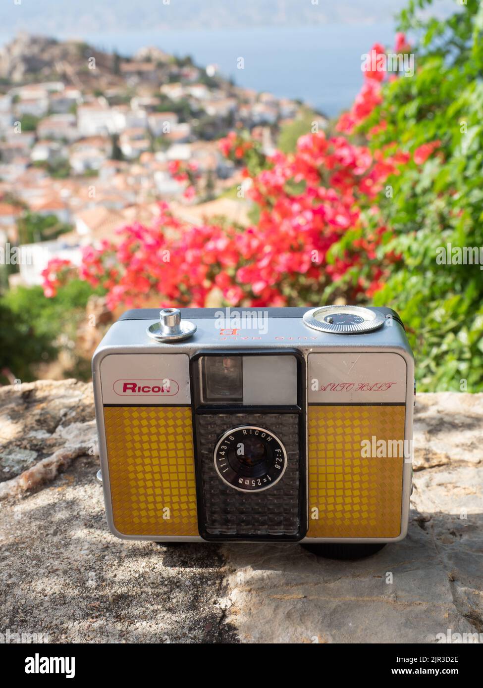 Yellow retro vintage Ricoh camera holiday photos on Greek island Stock ...