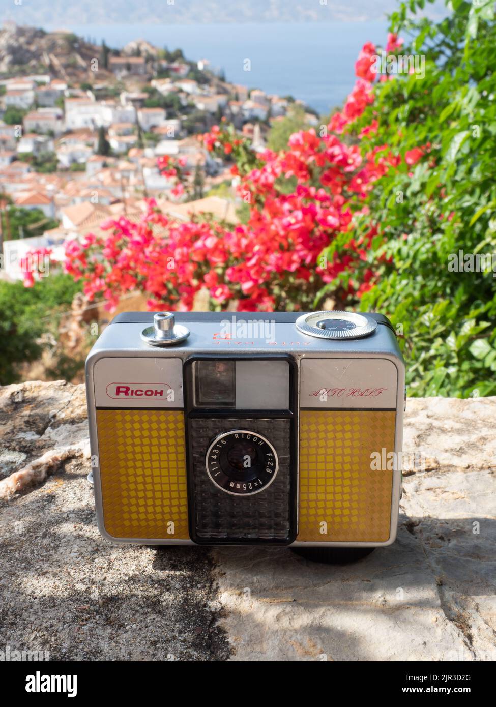 Yellow retro vintage Ricoh camera holiday photos on Greek island Stock ...