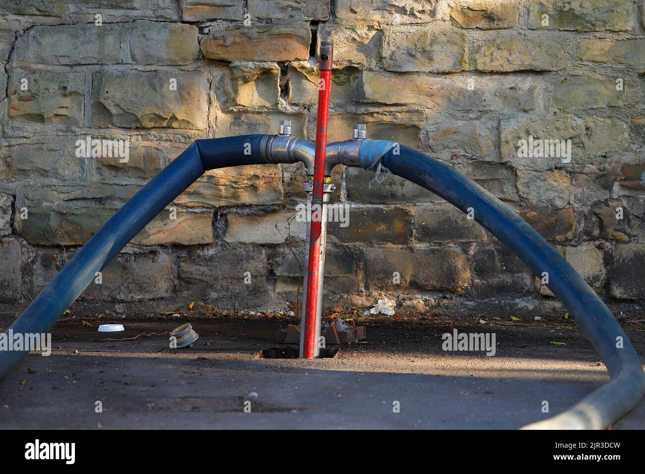 Fire hydrant with 2 hoses attached & being used to supply water to ...